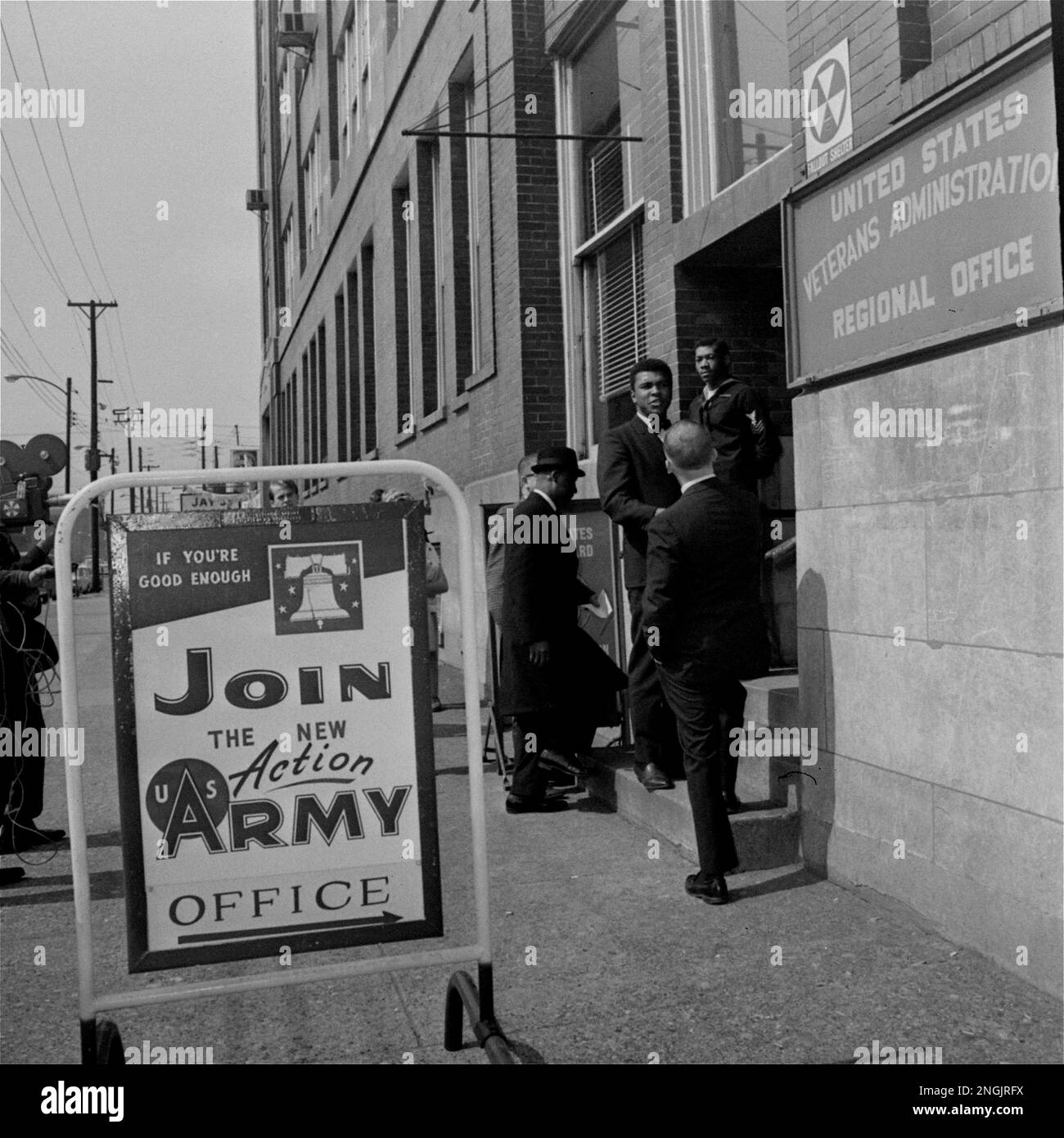 Heavyweight boxing champ Cassius Clay, paused on the step and greeted a ...