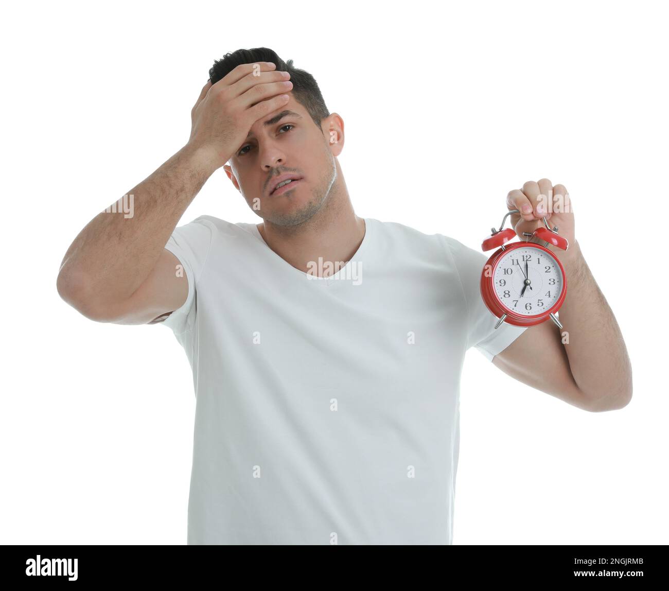 Emotional man with alarm clock on white background. Being late because ...