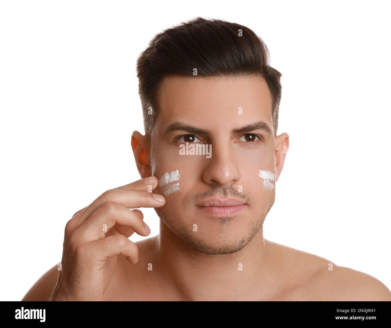 Handsome man applying face cream on white background Stock Photo - Alamy