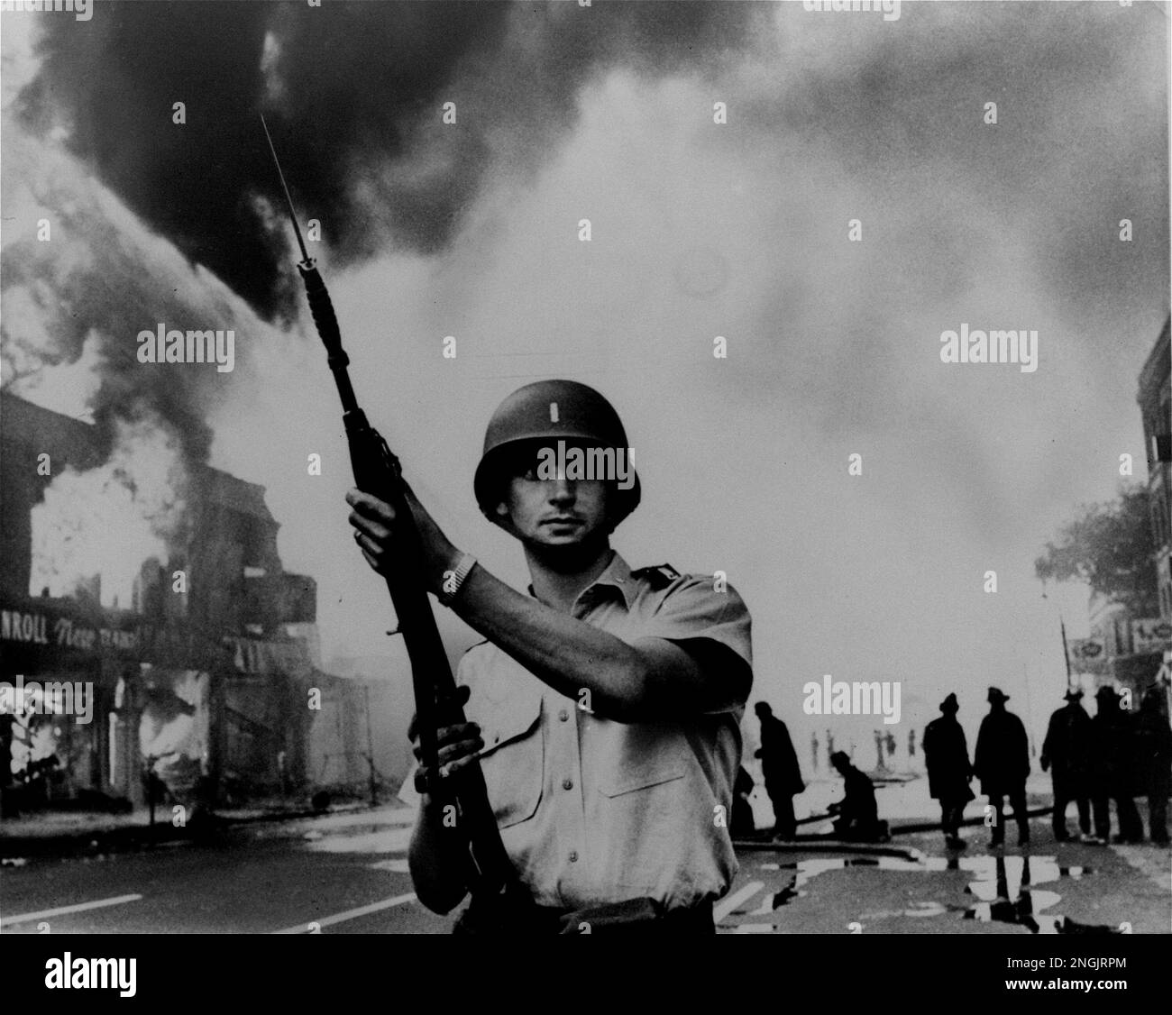 A National Guardsman stands at the ready at a Detroit intersection ...