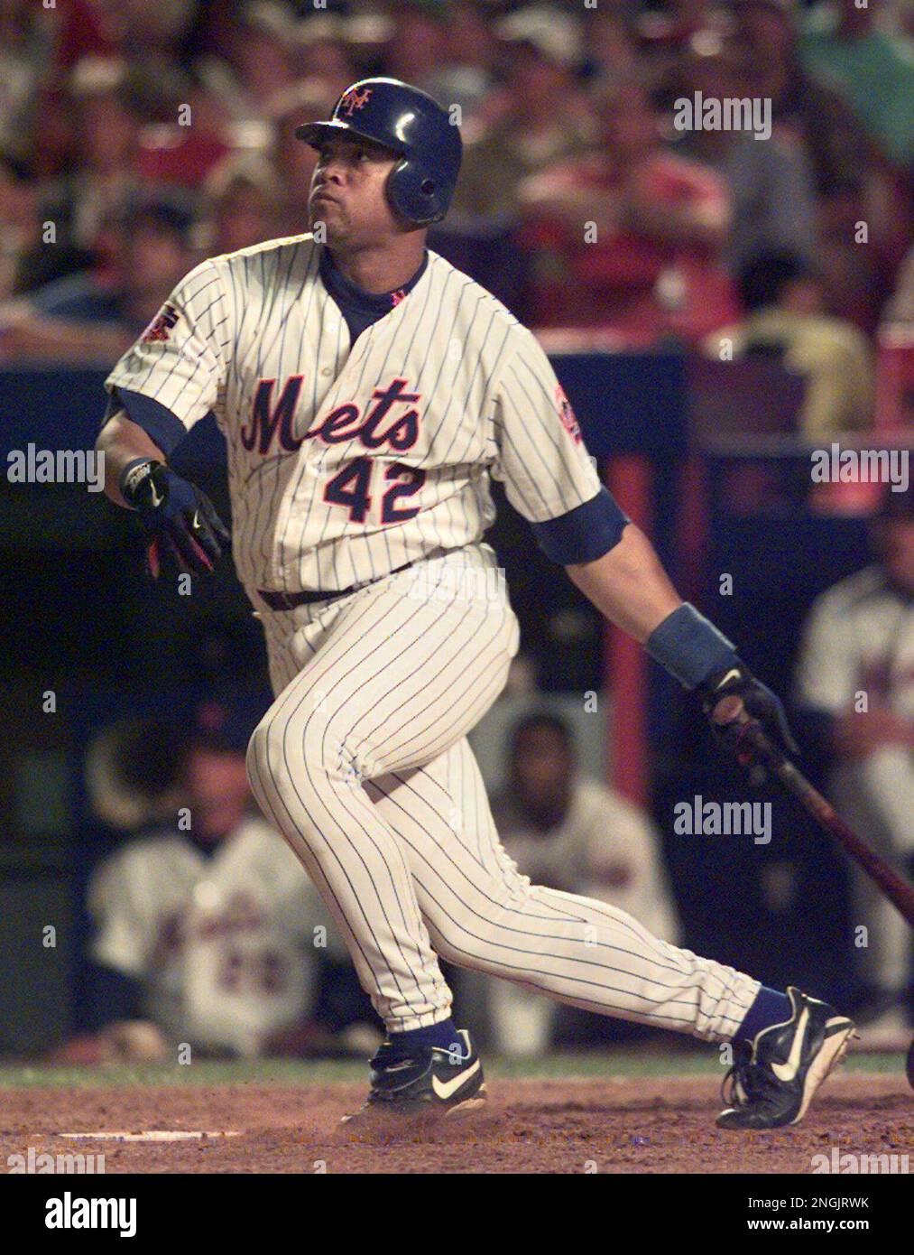 New York Mets' Butch Huskey hits a sacrifice fly in the first inning ...