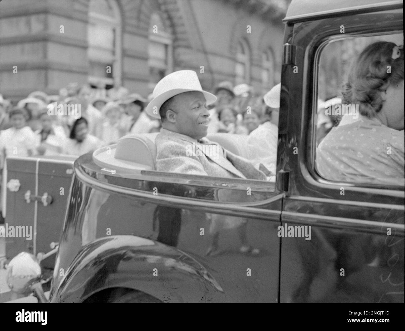 Father Divine, whose followers call him God, rolls along Lennox Avenue ...