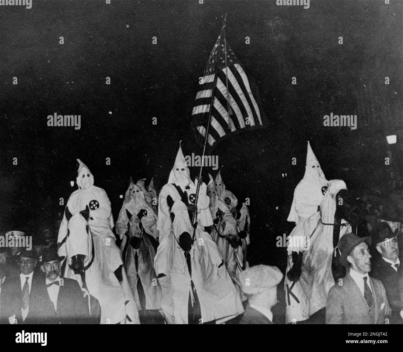 An unusual photo depicting the Ku Klux Klan in their regalia parading ...