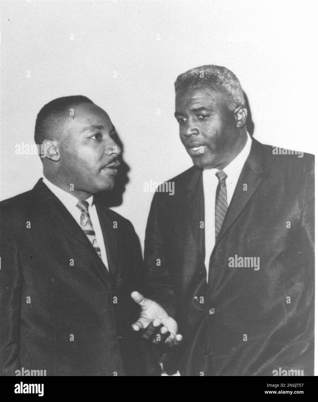 Dr. Martin Luther King, Jr. is shown with Jackie Robinson in the 1960s ...