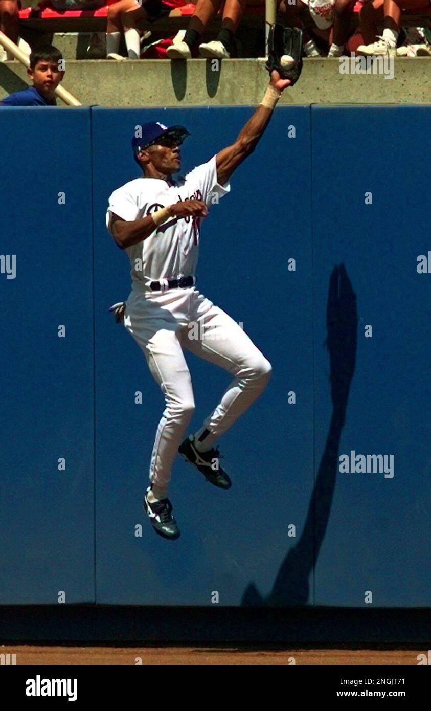 Los Angleles Dodgers centerfielder Otis Nixon leaps to rob the Montreal ...