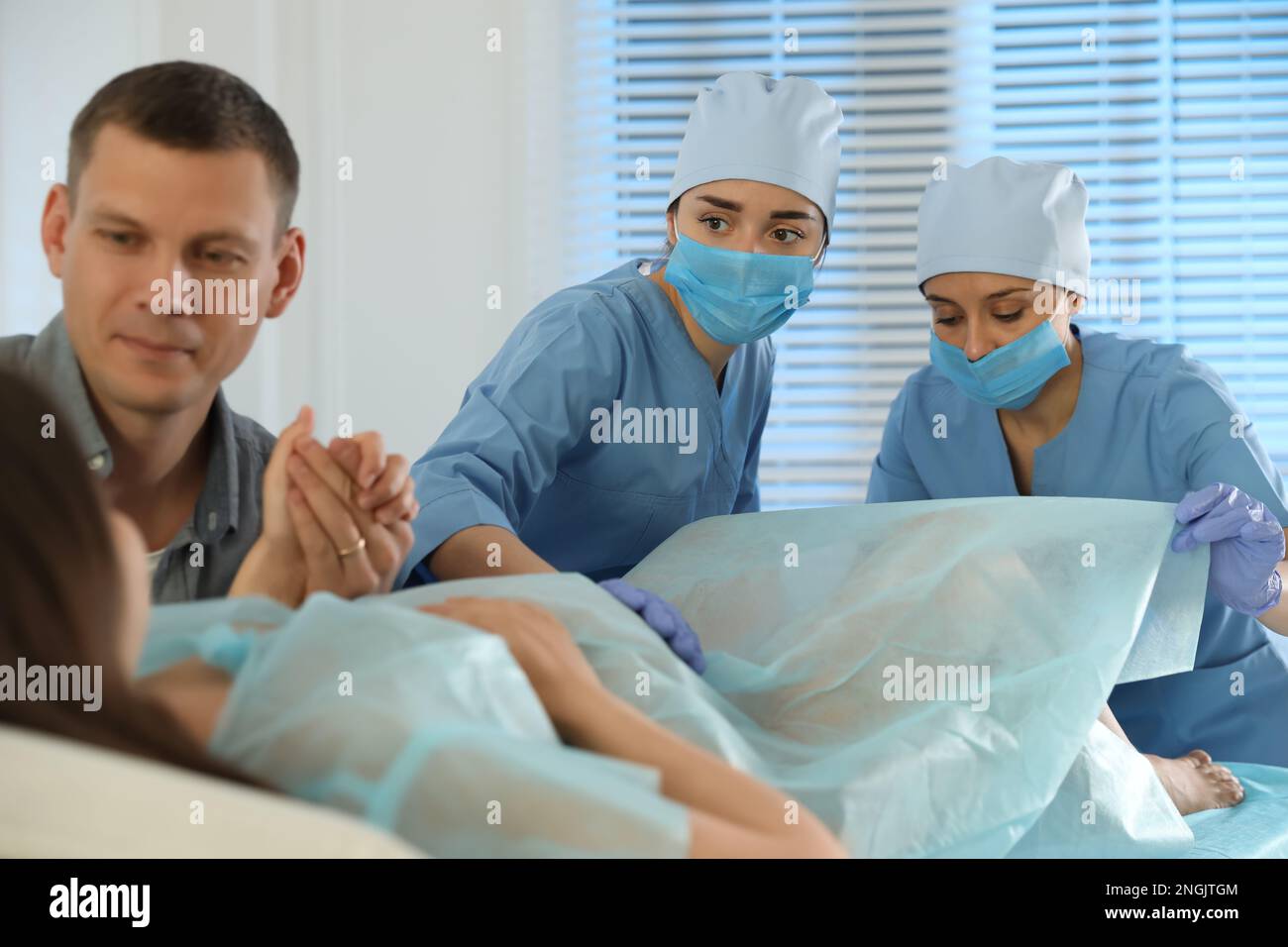Woman giving child birth in maternity hospital, focus on midwives Stock Photo - Alamy
