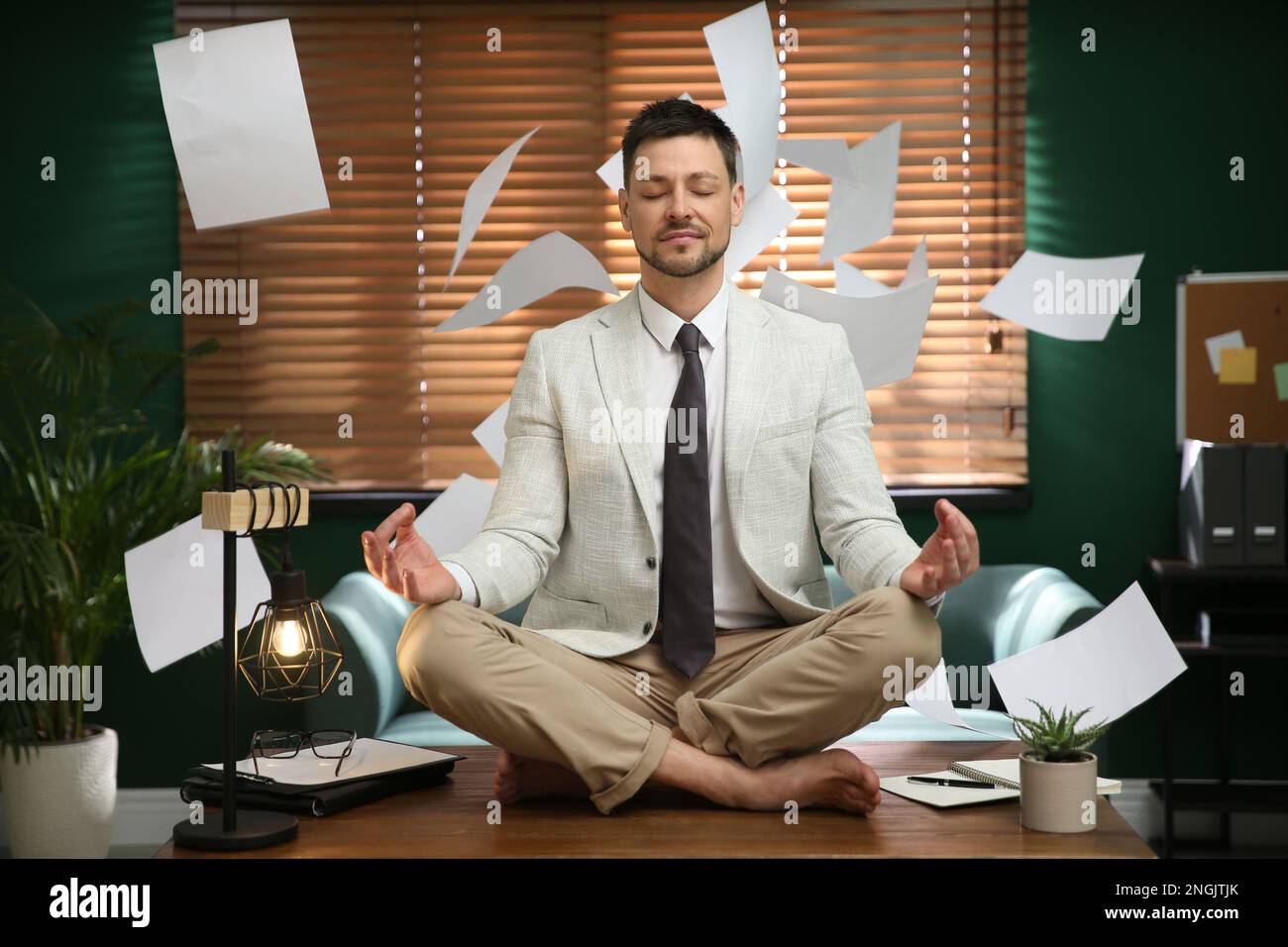 Business man meditating on desk hi-res stock photography and images - Alamy