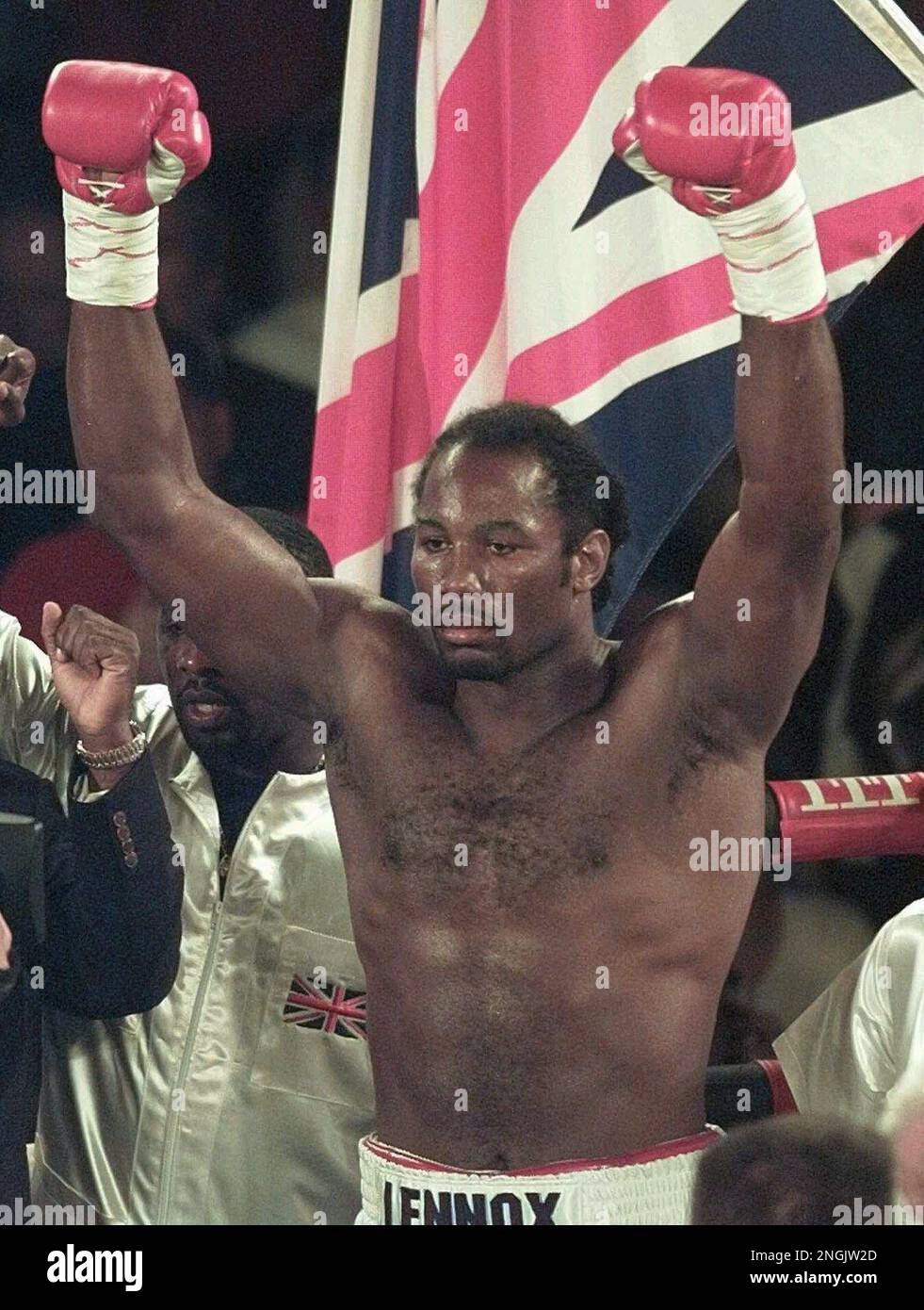 Lennox Lewis of London raises his arms at the beginning of his WBC ...
