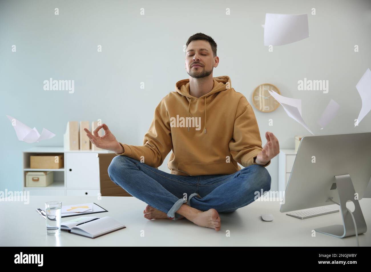 Business man meditating on desk hi-res stock photography and images - Alamy