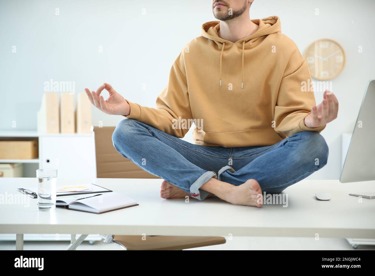Business man meditating on desk hi-res stock photography and images - Alamy