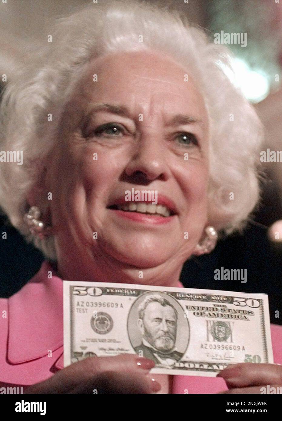 U.S. Treasurer Mary Ellen Withrow holds a new, re-designed $50 bill ...