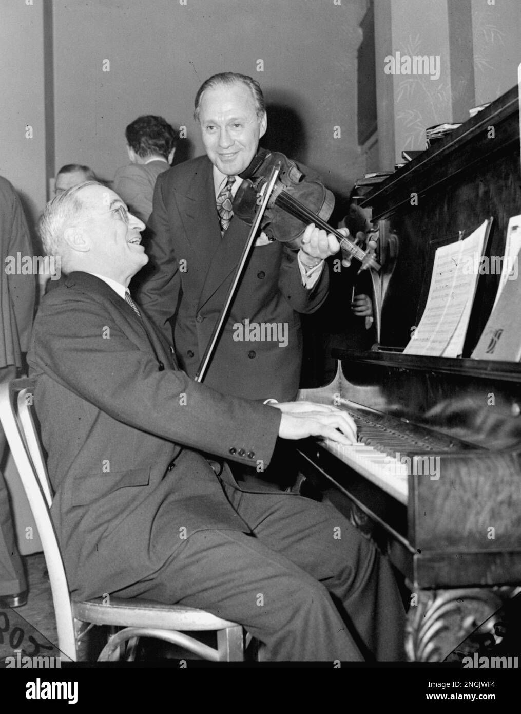 Vice President Harry Truman plays the piano accompaniment to violin ...