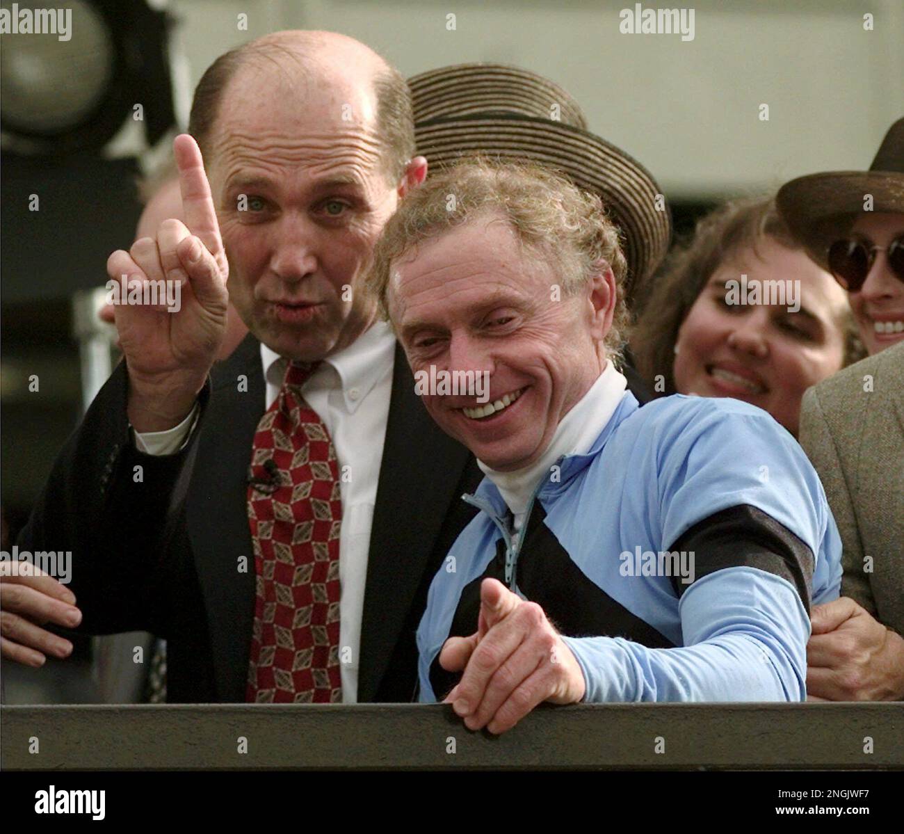 Touch Gold trainer David Hofmans gives a number one sign as jockey Chris McCarron reacts after ...