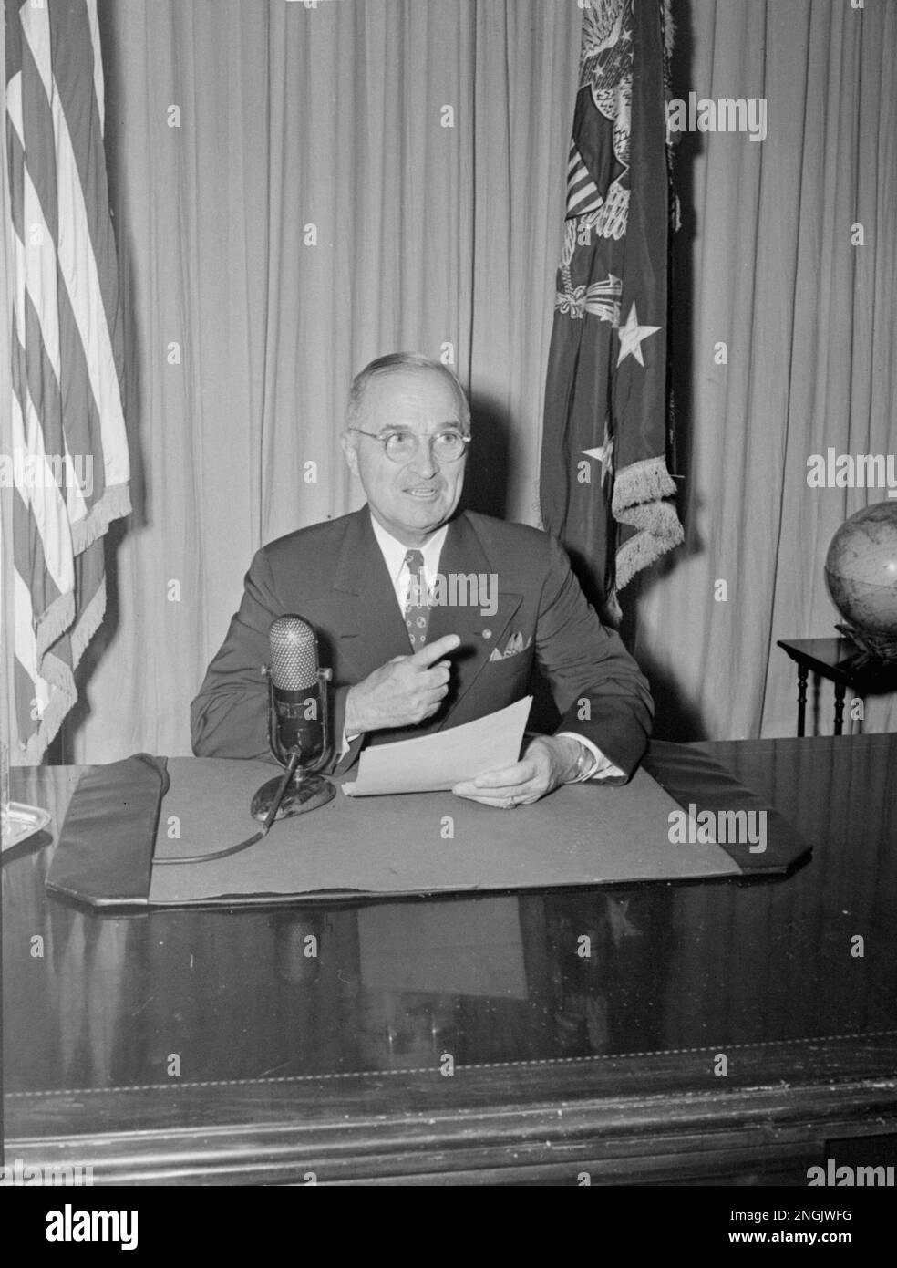 President Harry Truman sits before microphone at the White House on ...