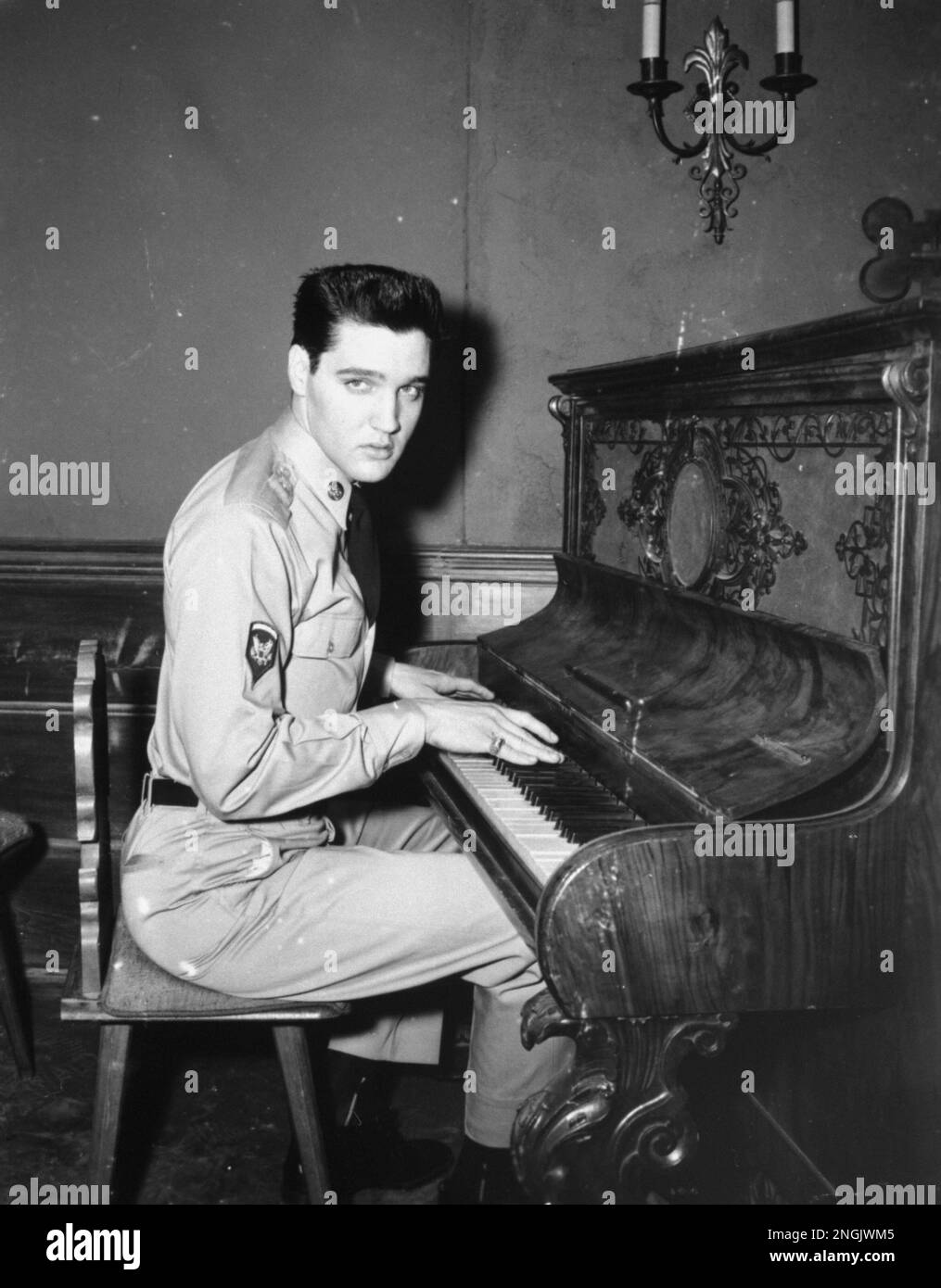 Private Elvis Presley is shown at the piano in the rec hall ...