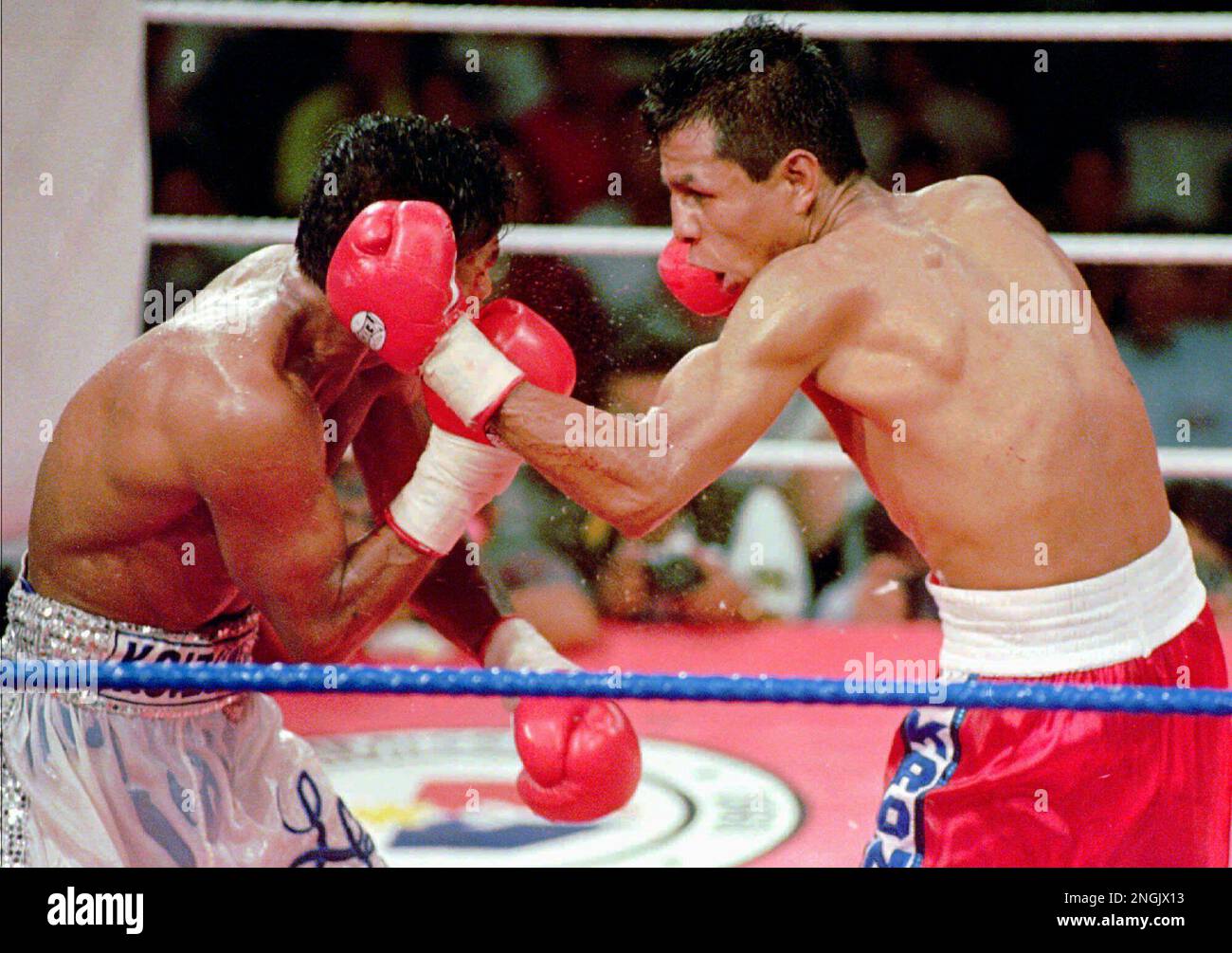 Mexican challenger Manuel Medina, right, hits Filipino champion Luisito ...