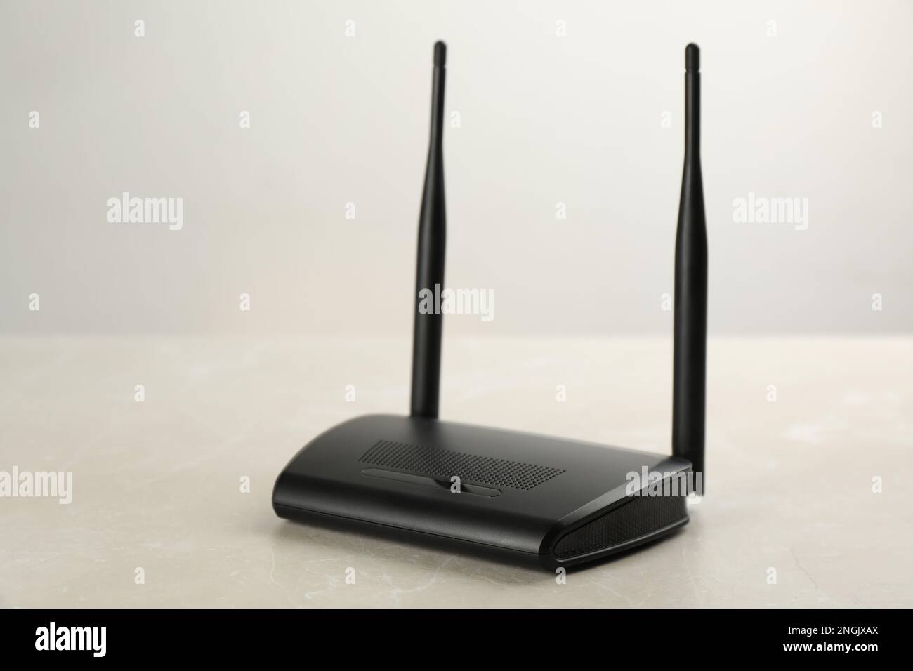 Modern Wi-Fi router on light grey marble background Stock Photo - Alamy