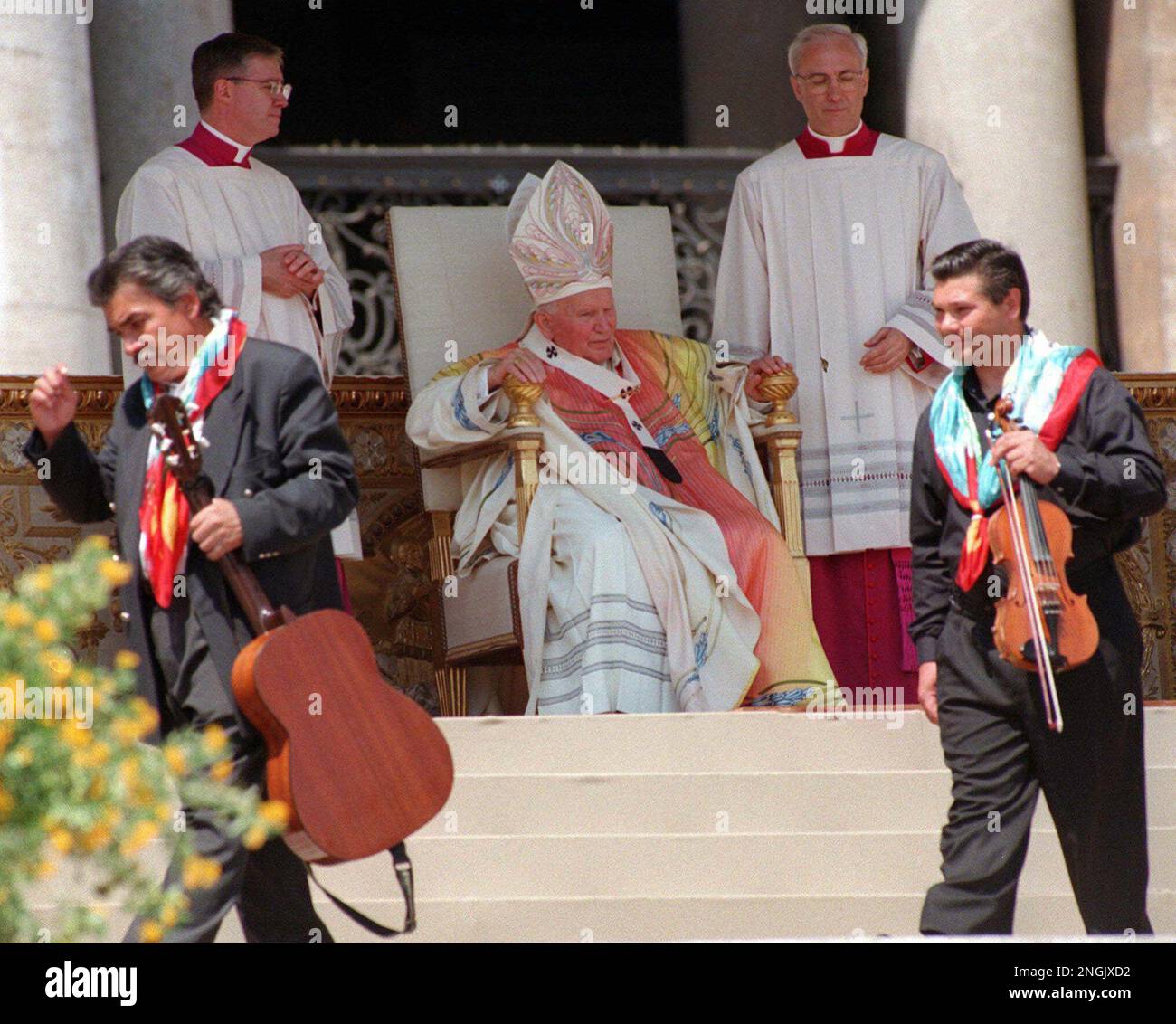 Two Gypsy players leave the altar after performing a Gypsy tune during ...