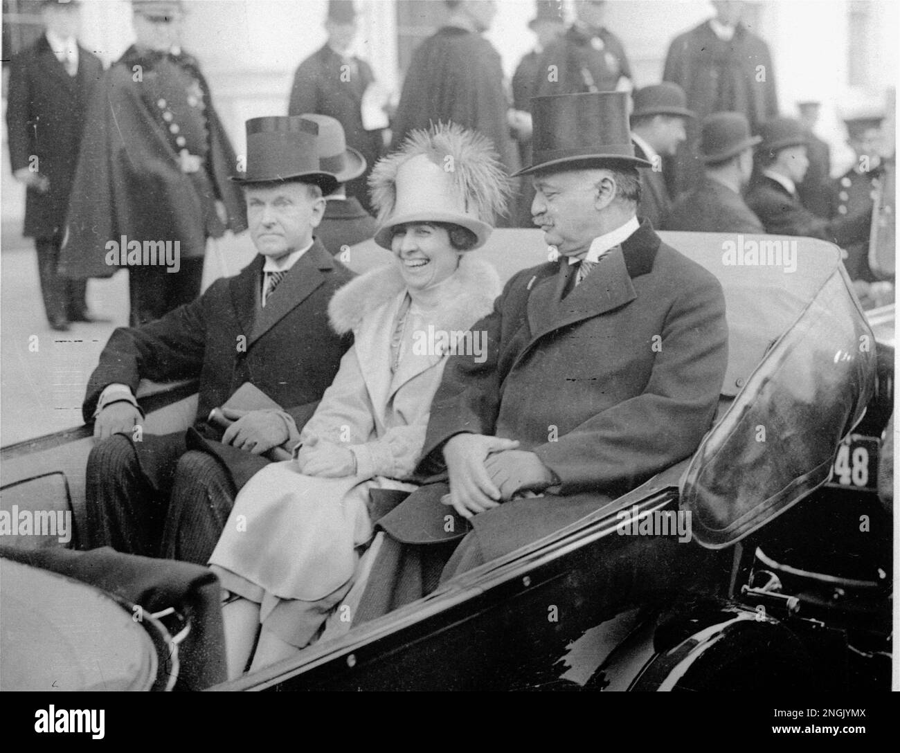 Calvin Coolidge, left, wears wing collar and muted top hat en route to ...