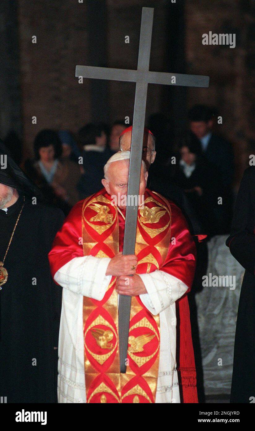 Pope John Paul II carries a 5-foot (2-meter) black cross for the first ...