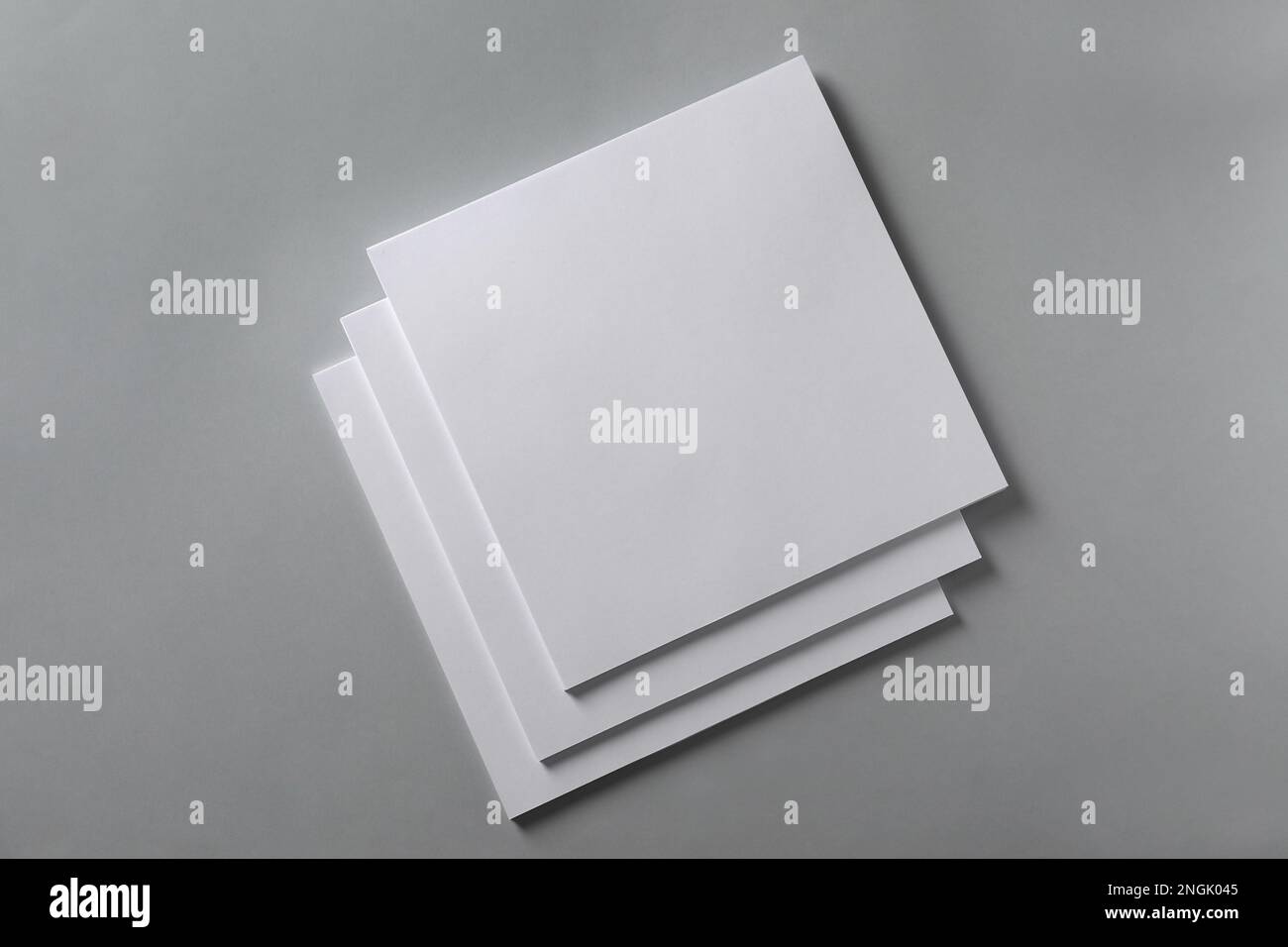 Stack of blank paper sheets for brochure on light grey background, top ...