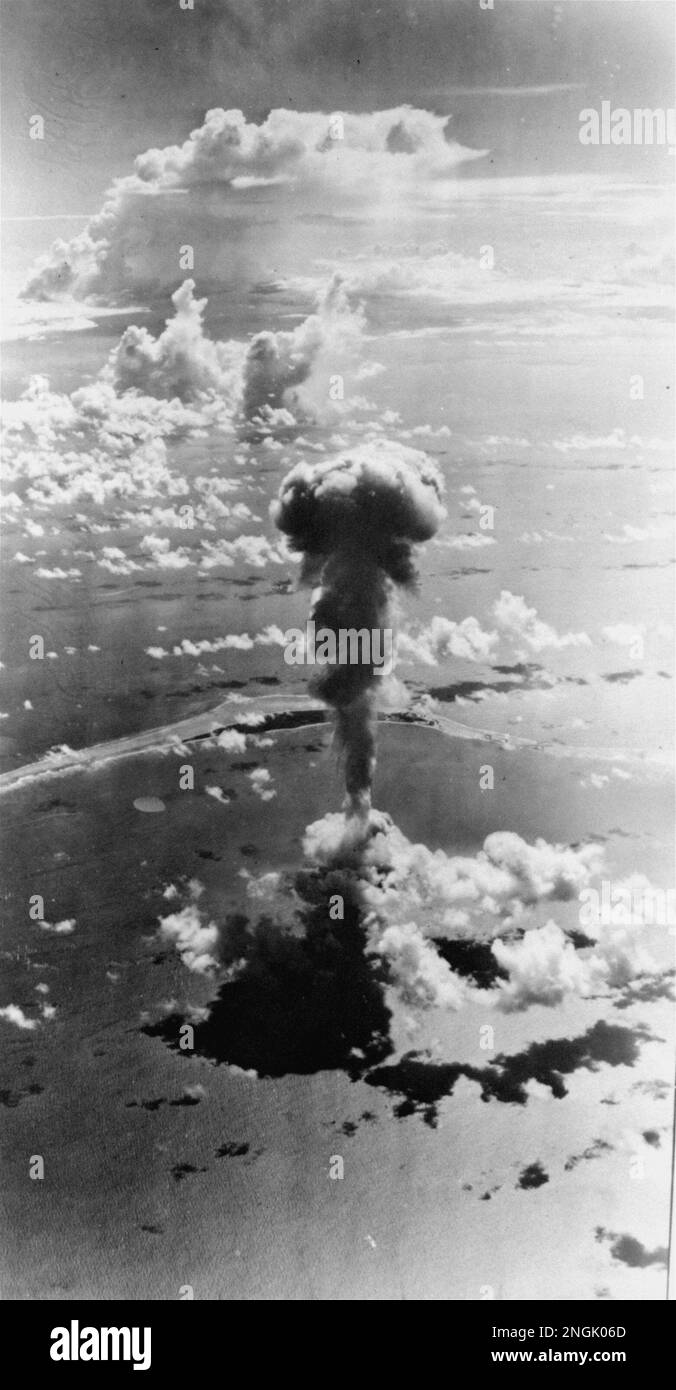 A mushroom-topped column of smoke and gas, brighter than the sun, rises ...