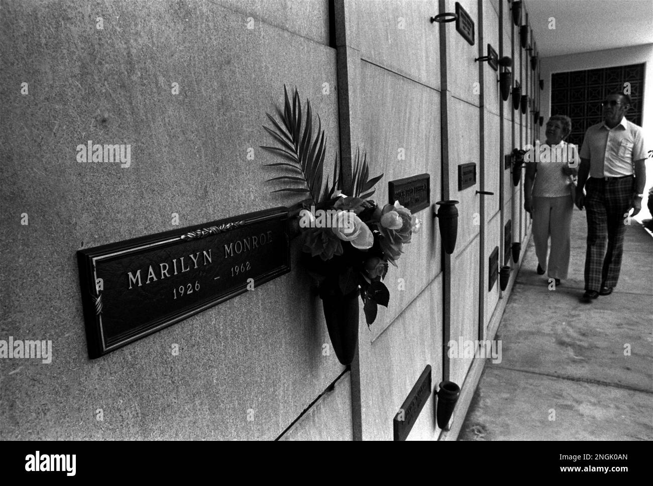 People walking near the grave of Marilyn Monroe in Westwood Memorial Park, Los Angeles ...