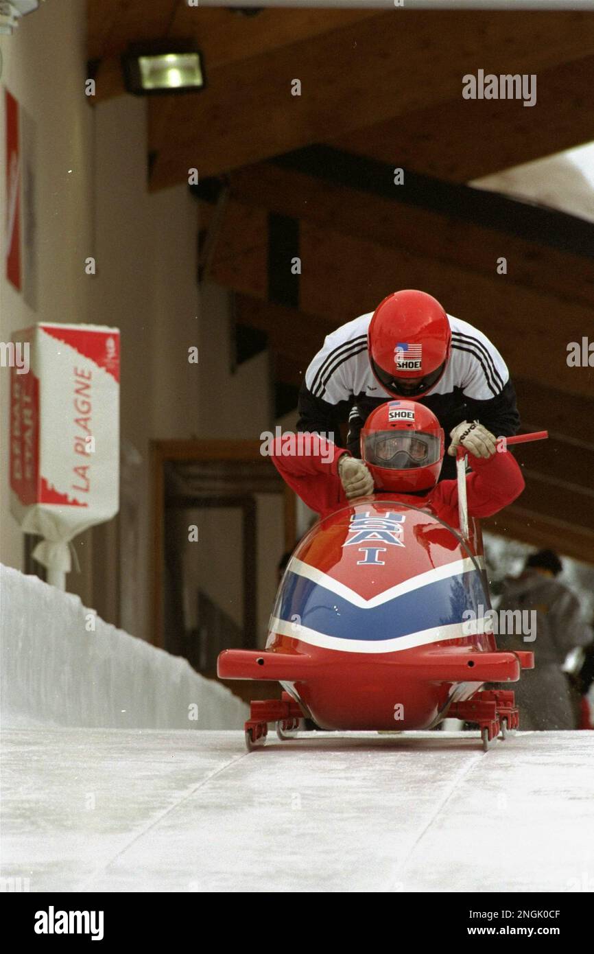 US driver Brian Shimer, front, is pushed by brakeman Herschel Walker at ...