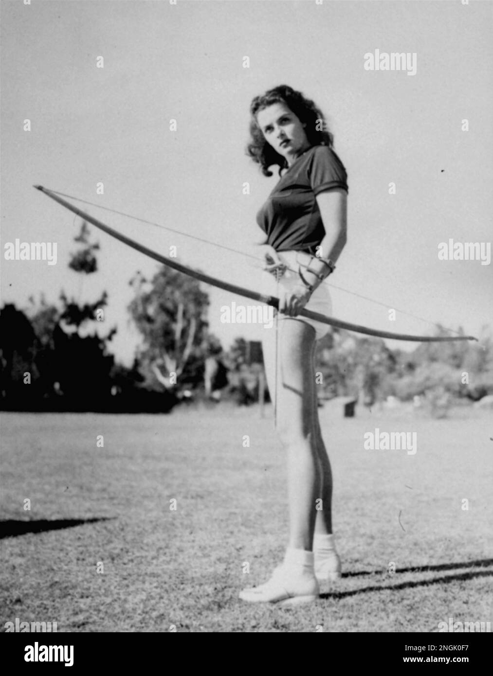 Actress Jane Russell tests her skill with a bow and arrow, July 25 ...