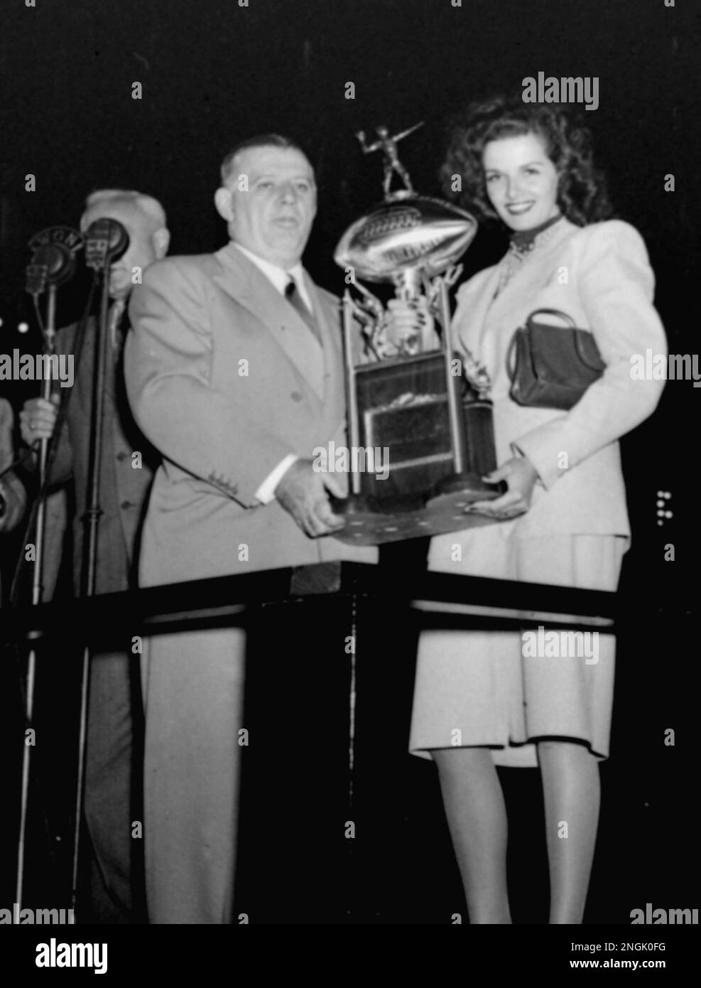 Film actress Jane Russell receives a trophy emblematic of husband Bob ...