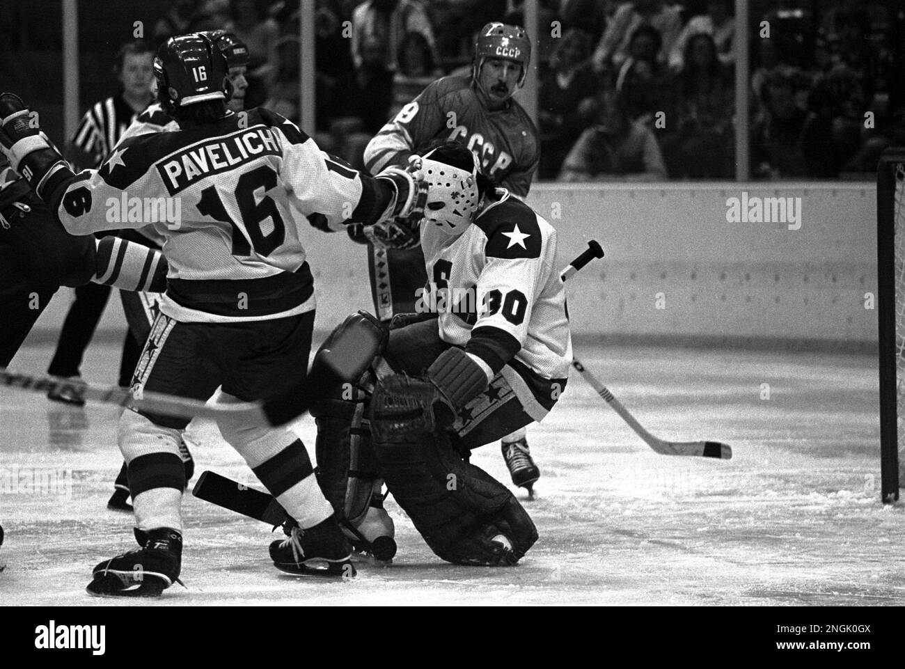 The puck goes past the feet of U.S. goalie Jim Craig as a tight defense ...