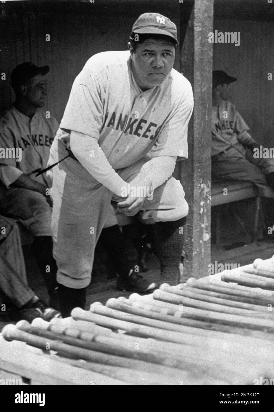 Babe Ruth, the Yankees' big bludgeon man, stands in the dugout with a ...