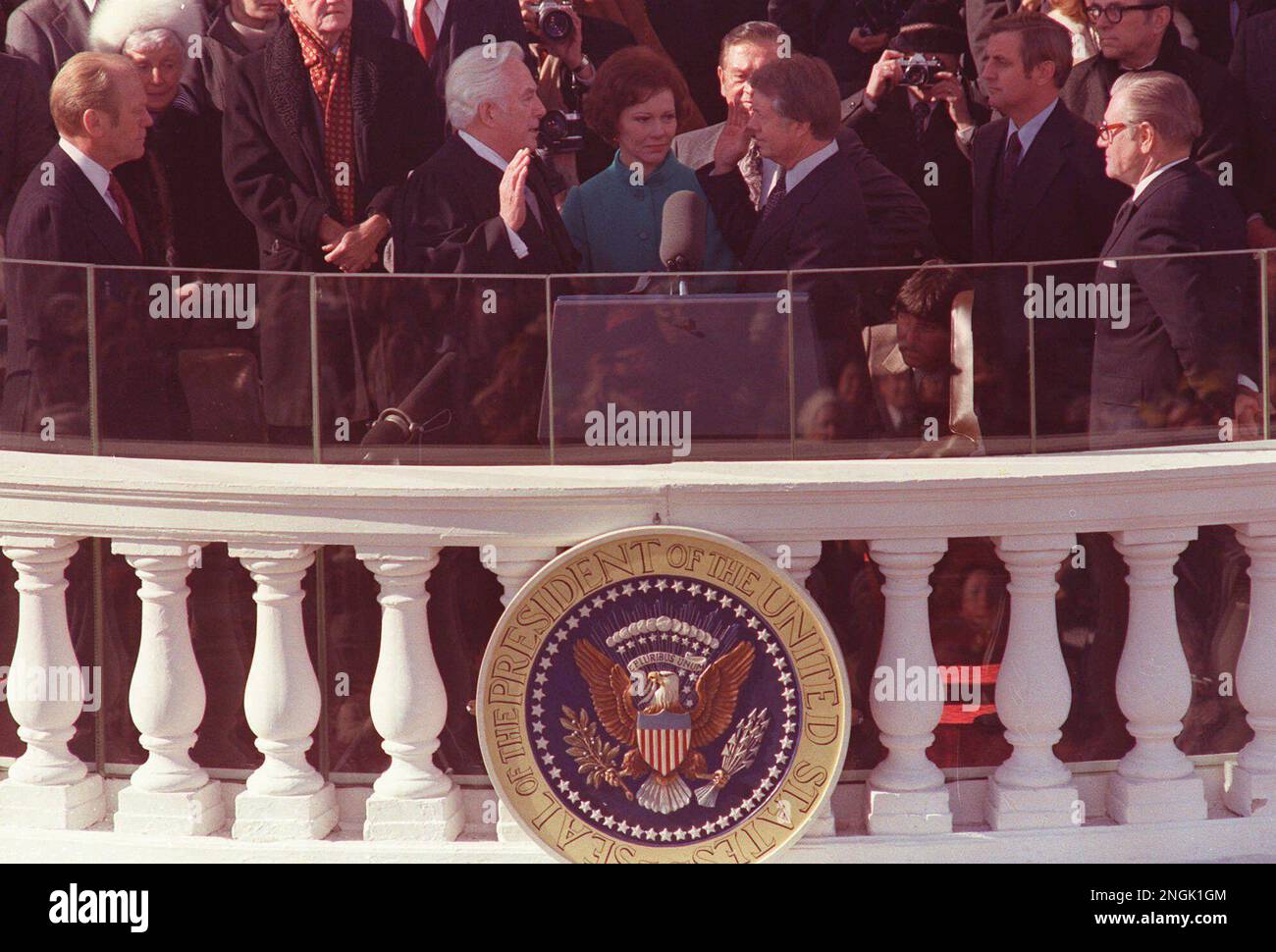 Jimmy Carter takes the oath of office, as his wife, Rosalynn, holds the ...