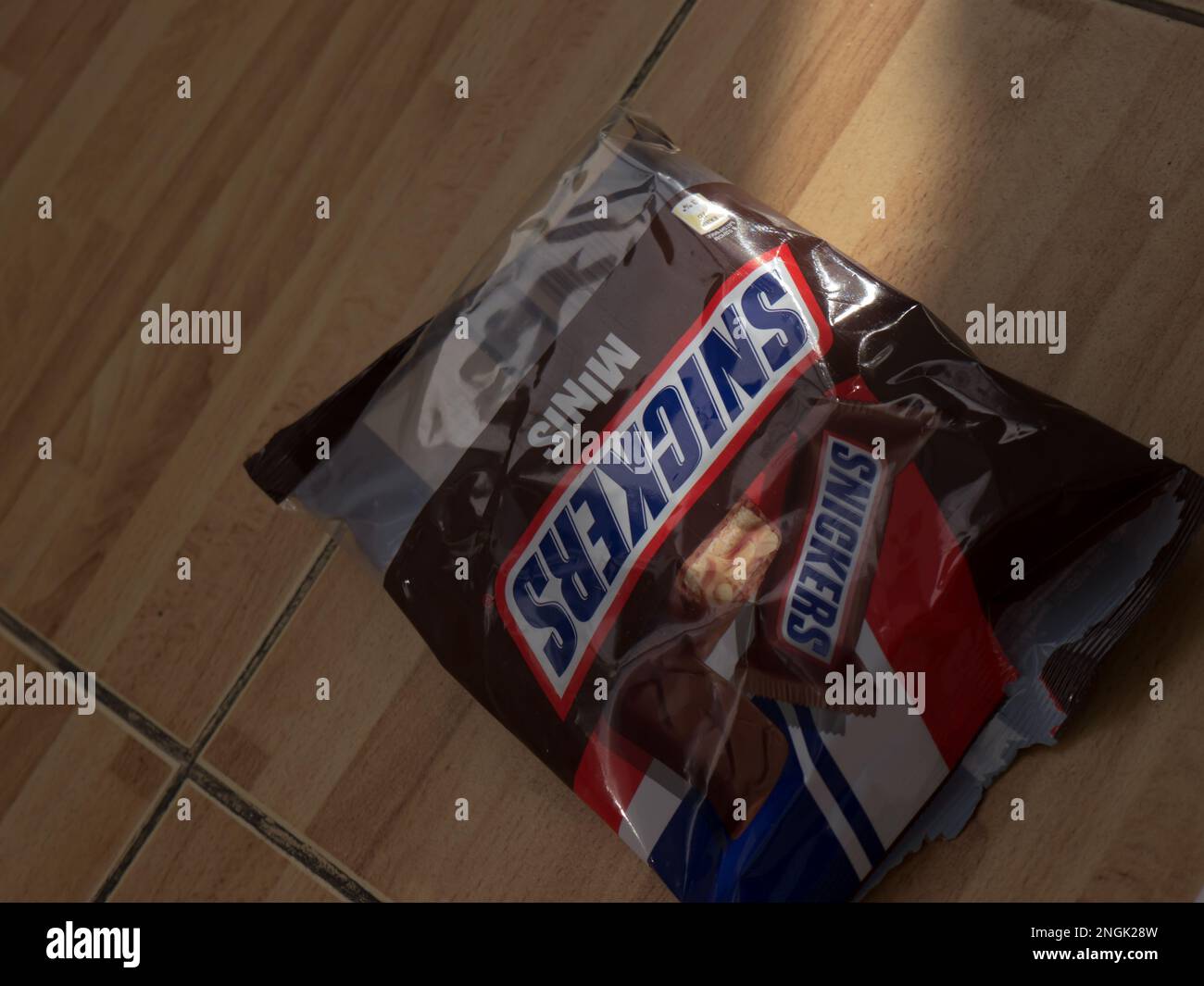 Сhocolate bar Snickers on a brown background Stock Photo - Alamy
