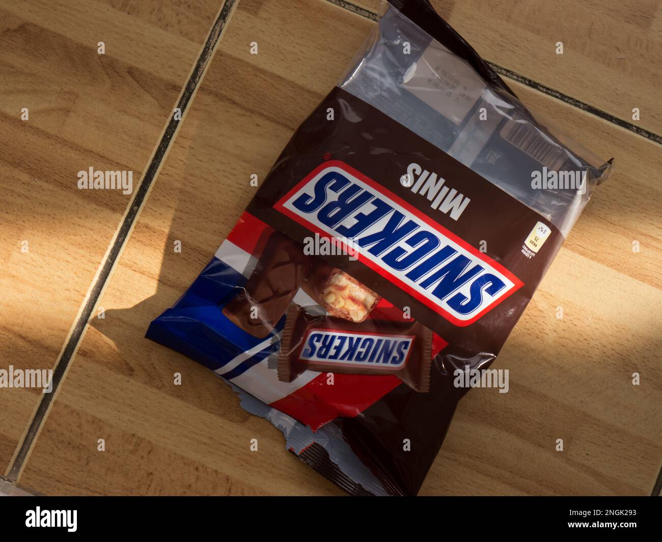 Сhocolate bar Snickers on a brown background Stock Photo - Alamy