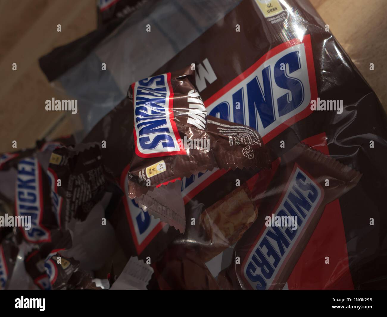Сhocolate bar Snickers on a brown background Stock Photo - Alamy