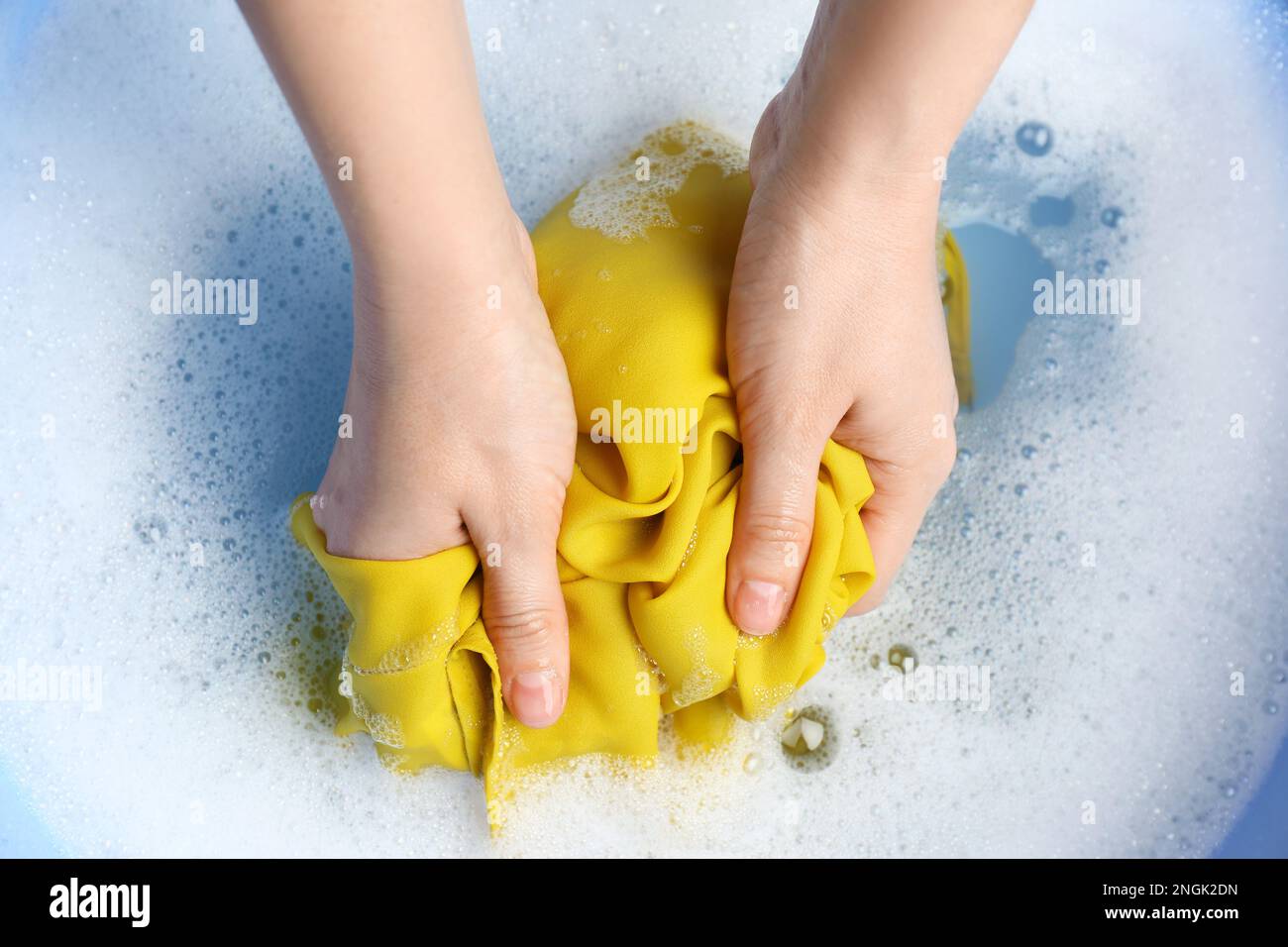 Top view of woman hand washing color clothing in suds, closeup Stock ...