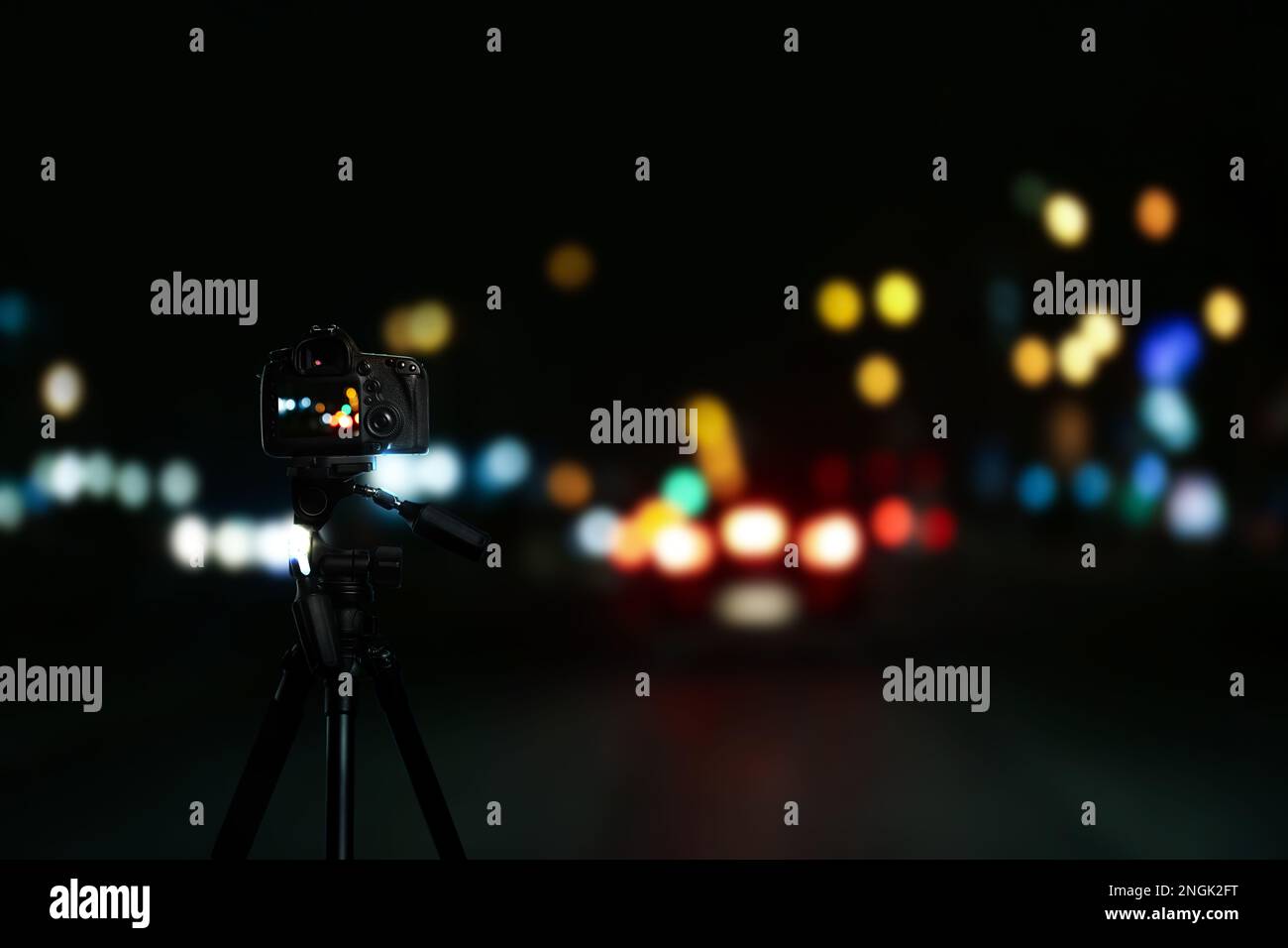 Taking photo of with camera mounted on tripod. Blurred view of city ...