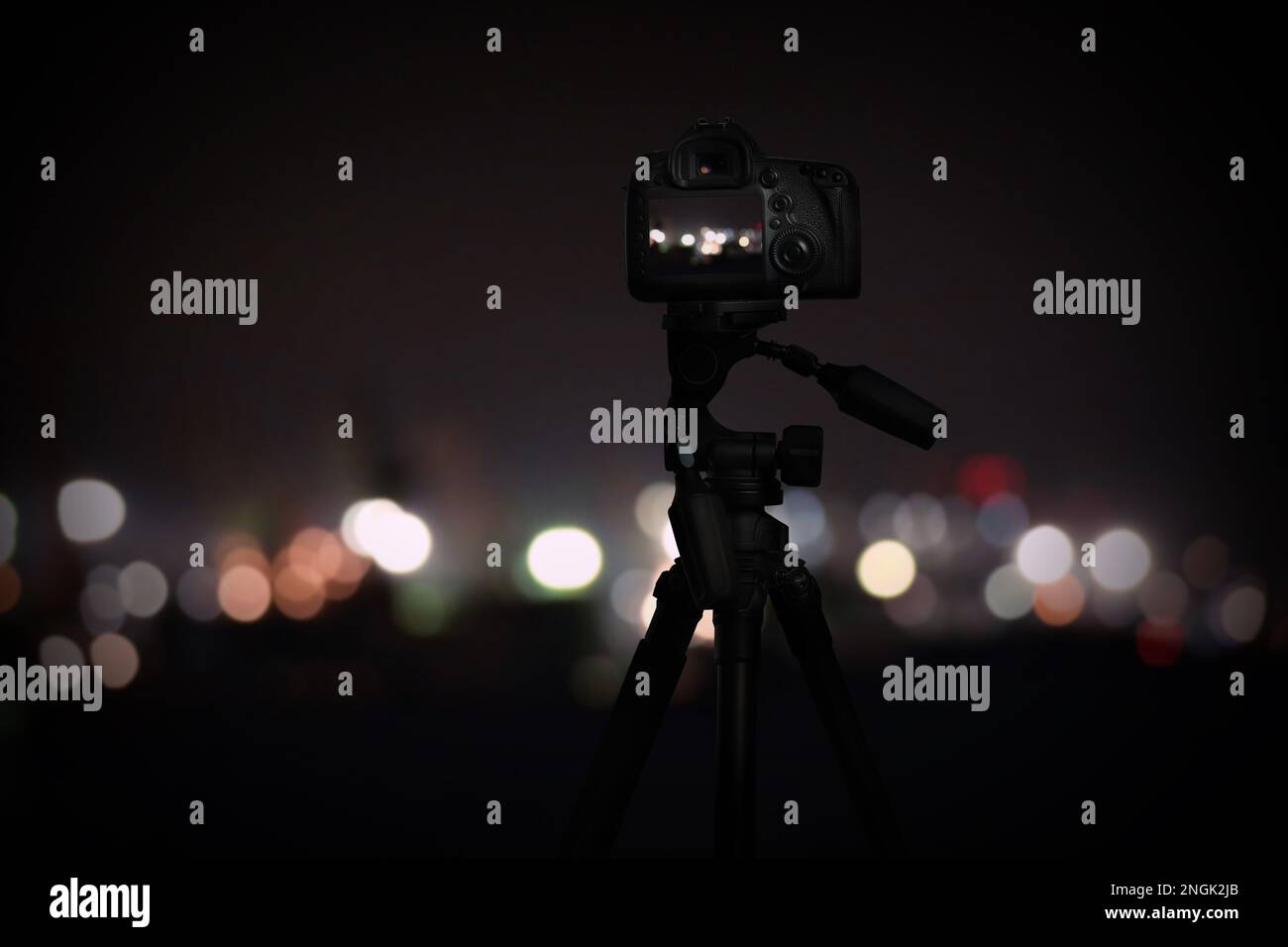 Taking photo of with camera mounted on tripod. Blurred view of city ...
