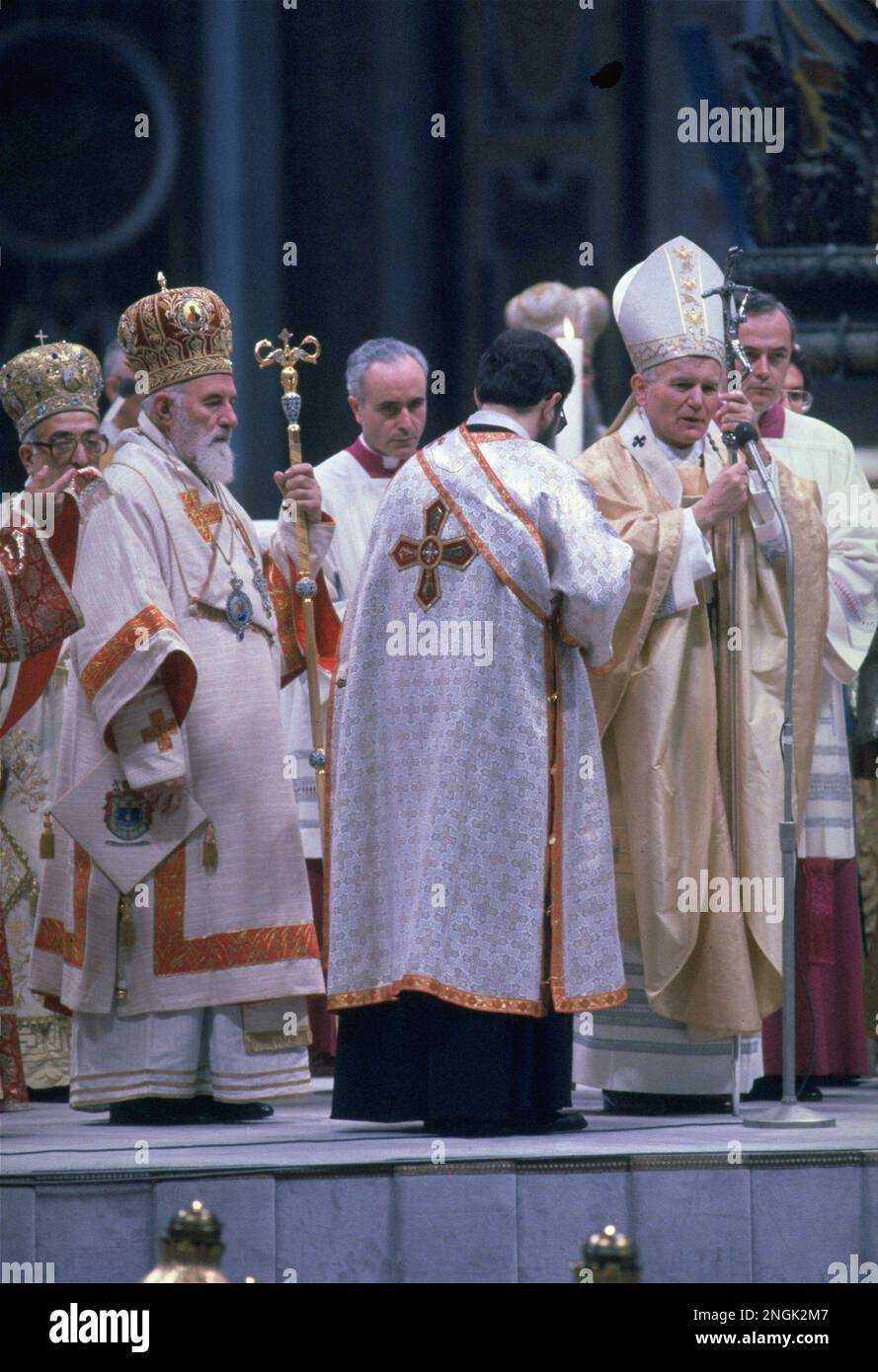 Pope John Paul II prays during a mass he celebrated along with ...