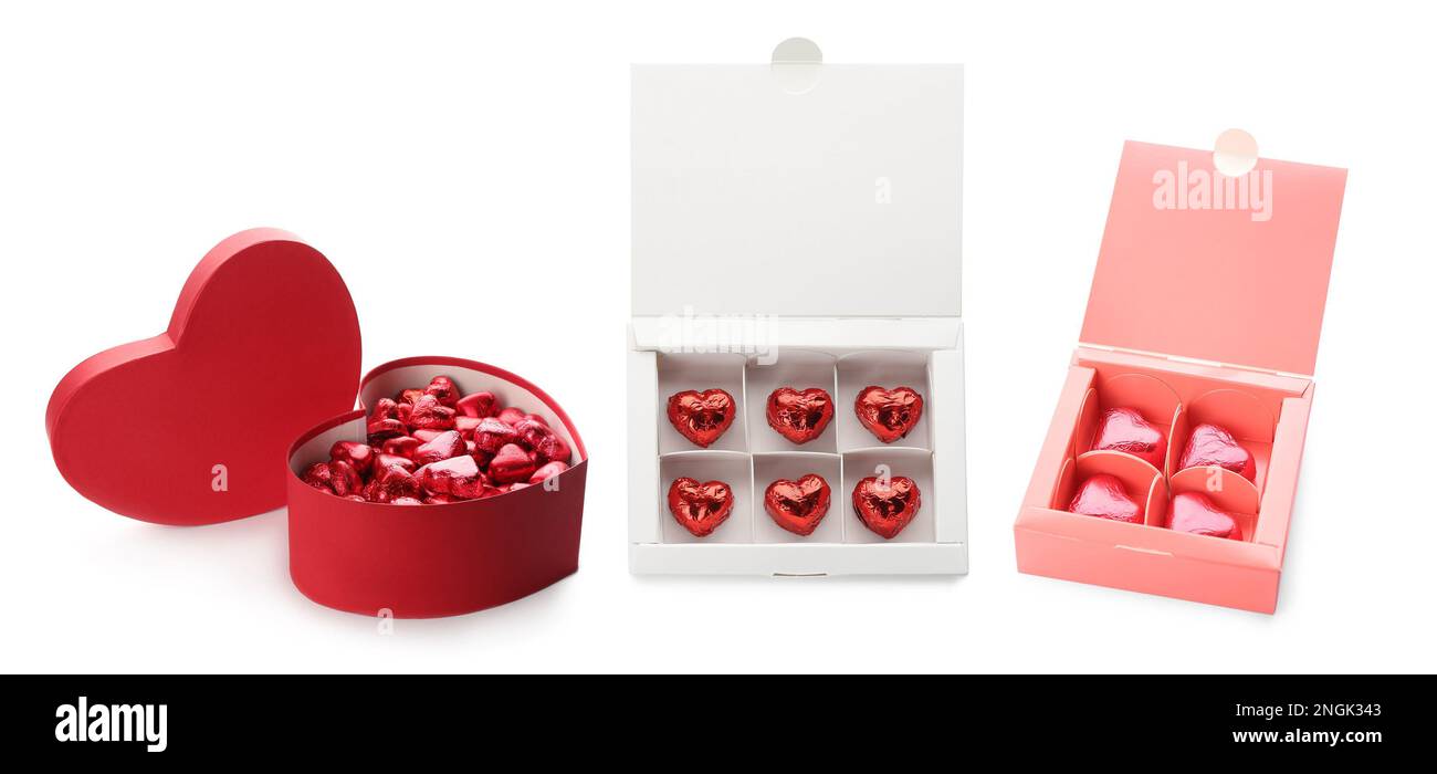 Set with delicious heart shaped chocolate candies in boxes on white ...