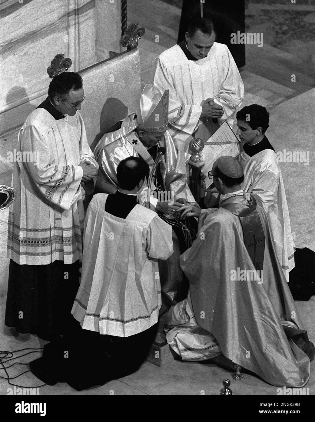 Pope John Paul II puts a gold ring on the finger of Cardinal Joseph L ...