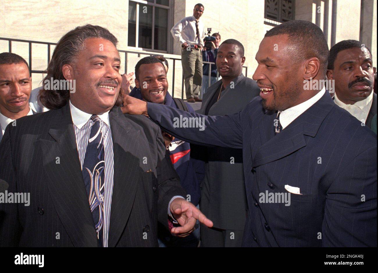 Mike Tyson, right, greets New York City activist Al Sharpton, left ...