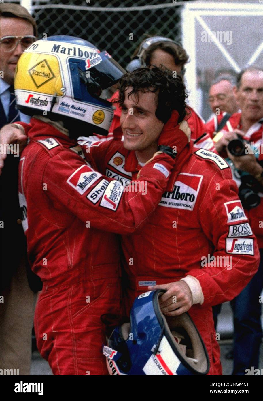 French driver Alain Prost, right, is congratulated by helmeted teammate ...