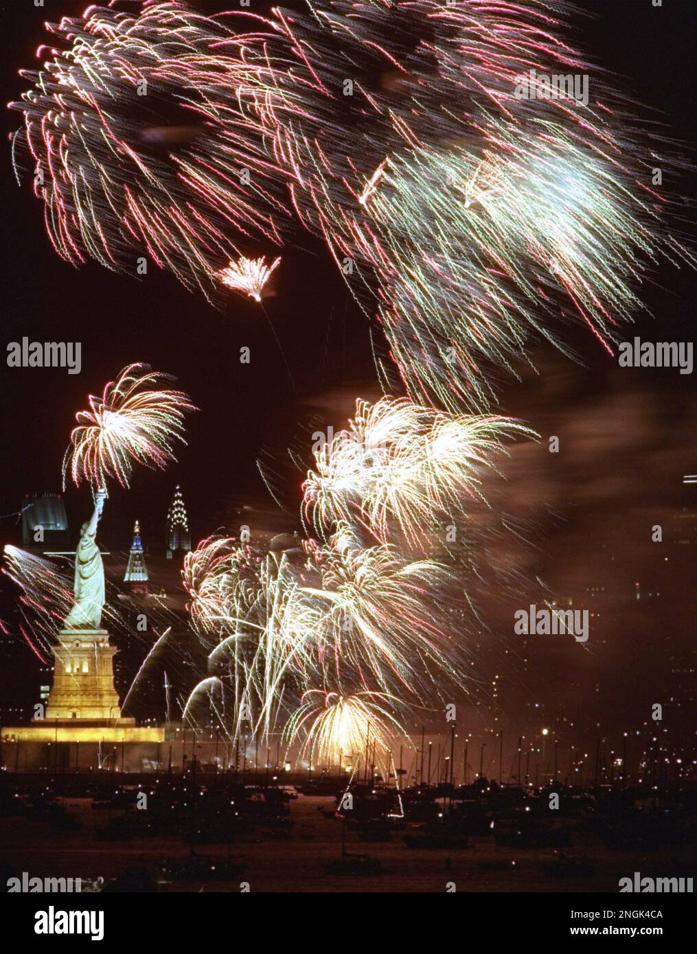 Fireworks burst around the Statue of Liberty in New York harbor during ...