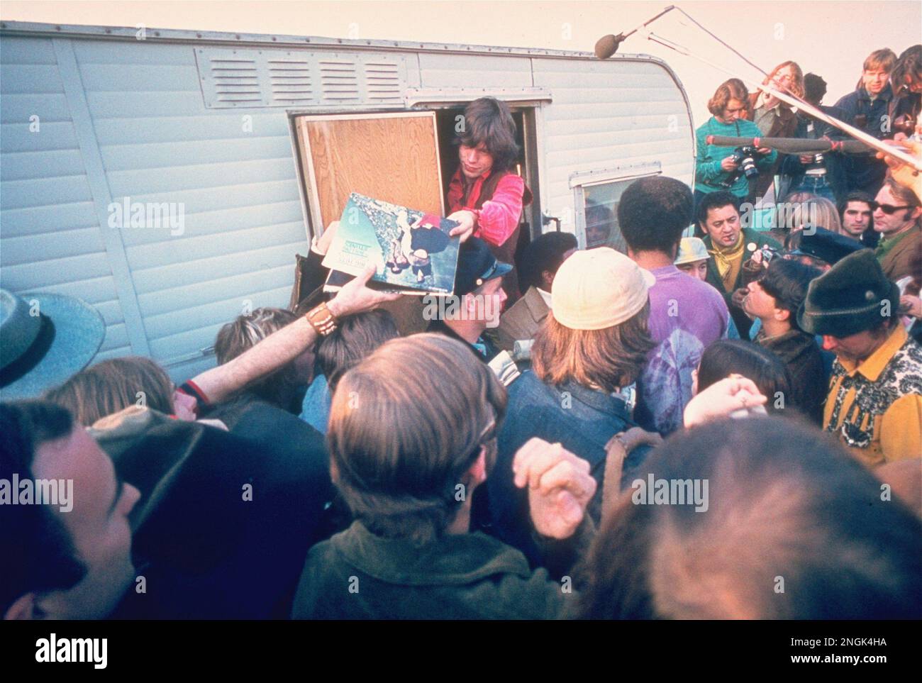 The Rolling Stones lead singer Mick Jagger signs autographs for fans at ...