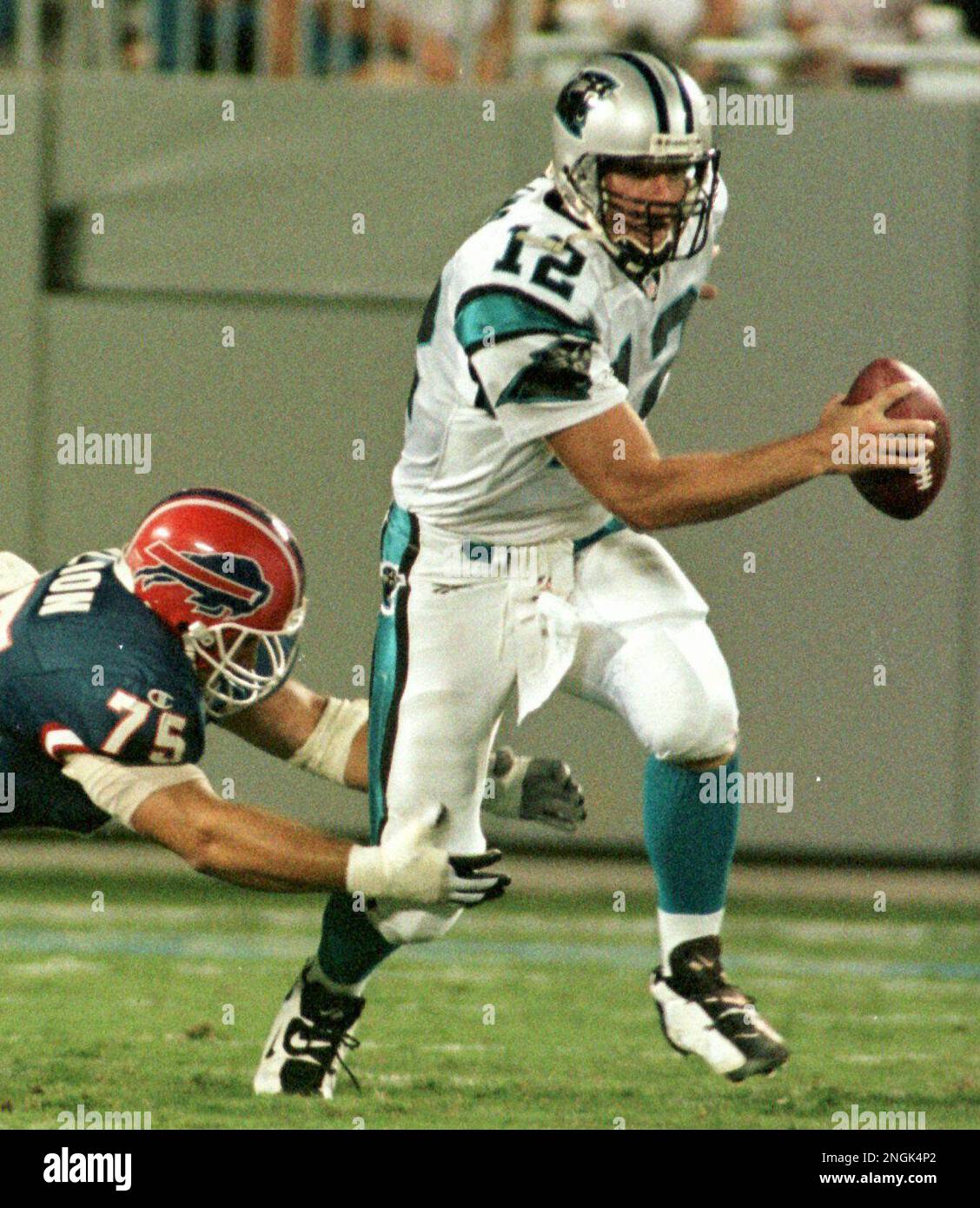 Carolina Panthers quarterback Kerry Collins (12) scrambles under ...