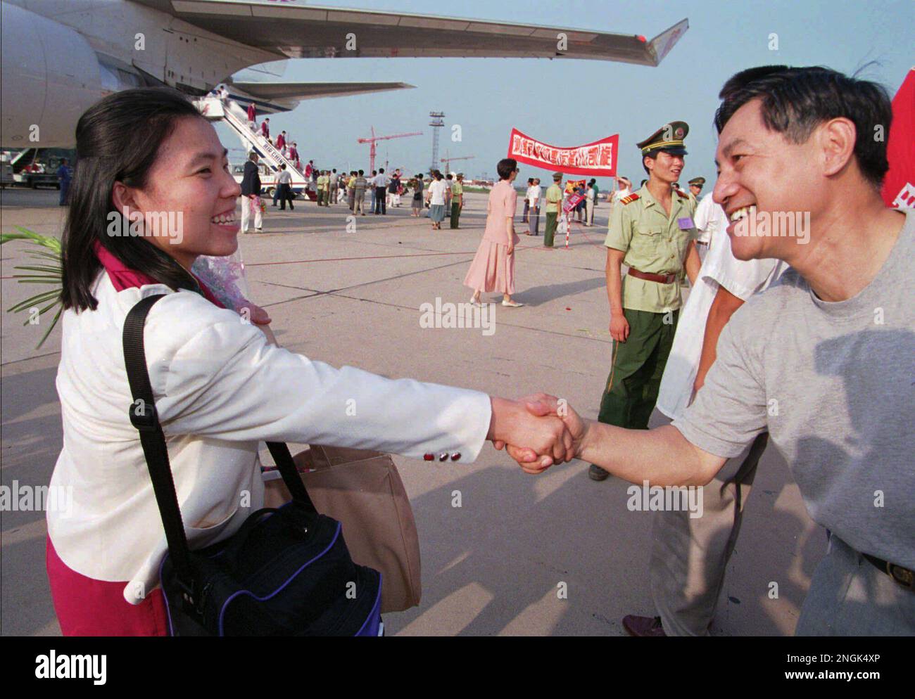 Chinese table tennis star Deng Yaping, left, is congratulated by a well ...