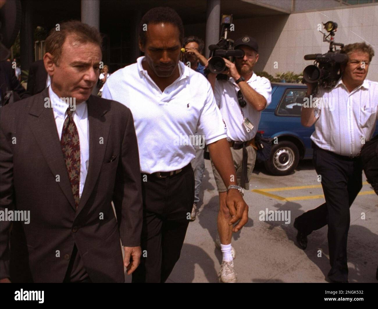Former NFL star O.J. Simpson, center, and his attorney Howard Weitzman ...