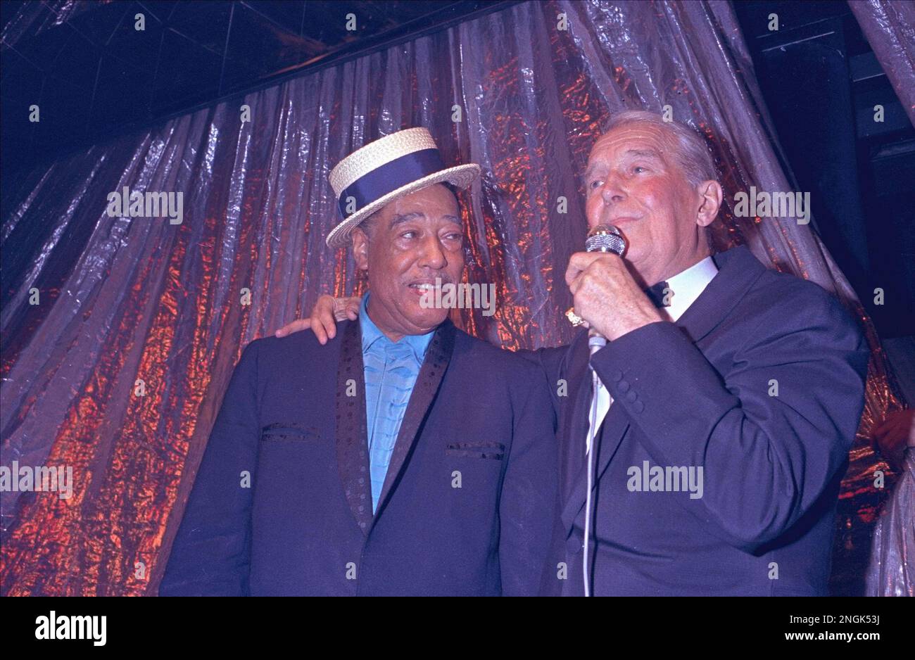 Jazz pianist, composer and band leader Duke Ellington wears a straw hat ...